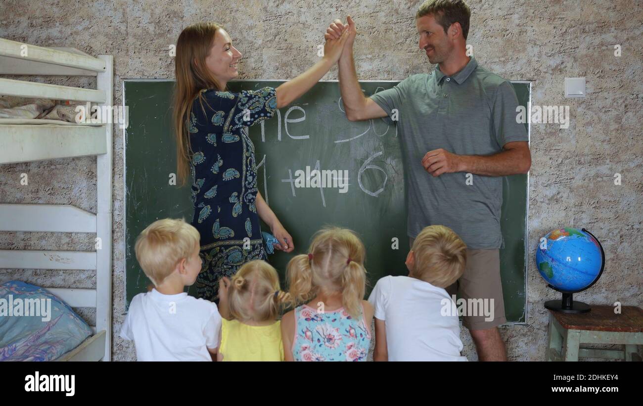 Home school concept. Parents give children a math lesson at the ...