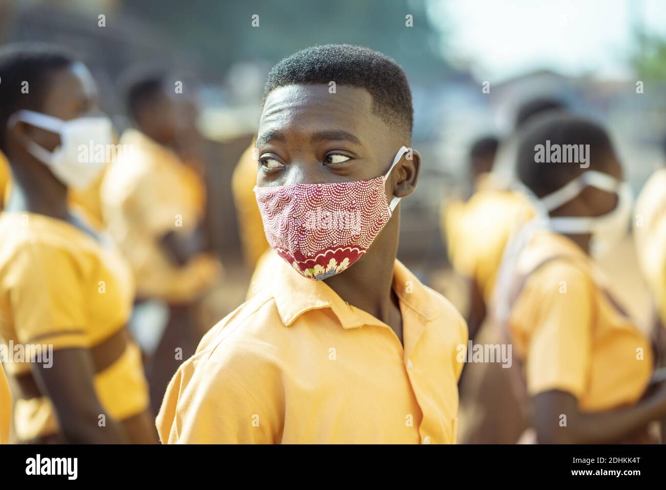 A view of an African girl wearing a protective colorful mask and ...