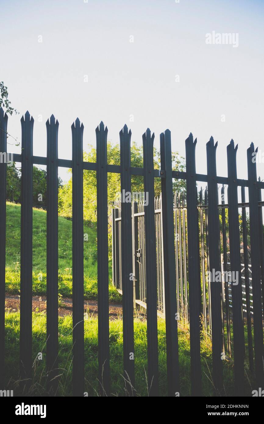 A metal security fence around a rural compound Stock Photo - Alamy