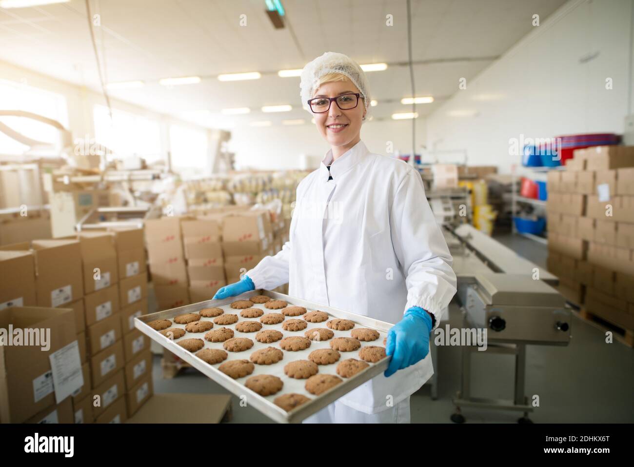 Young beautiful dedicated female worker in sterile cloths carrying ...