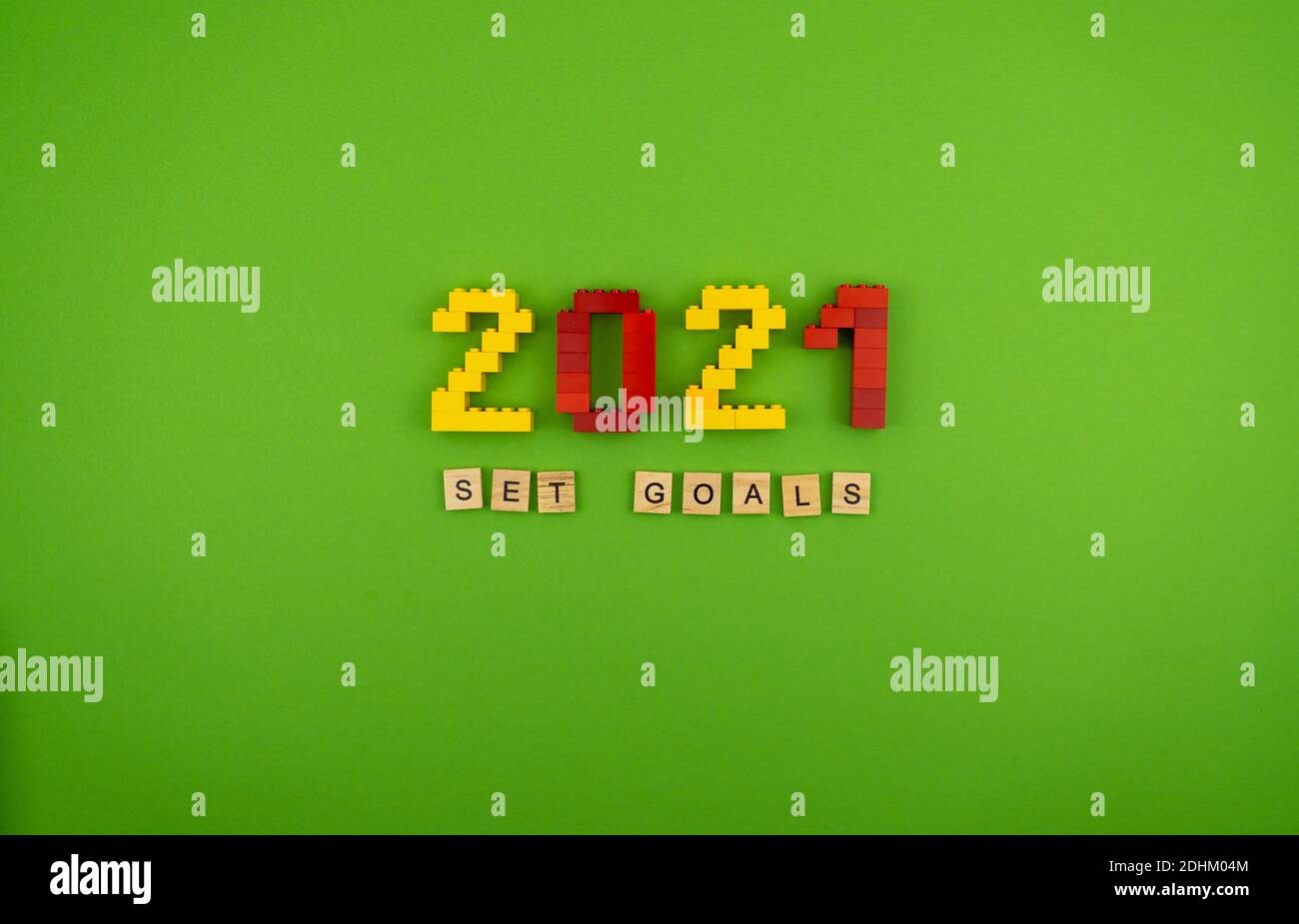 The word goal 2021 is lined with wooden letters on a green background ...