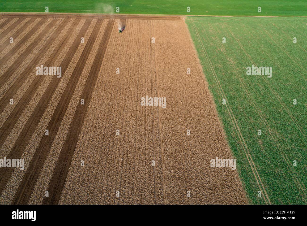 Aerial flight of field with tractor Stock Photo - Alamy