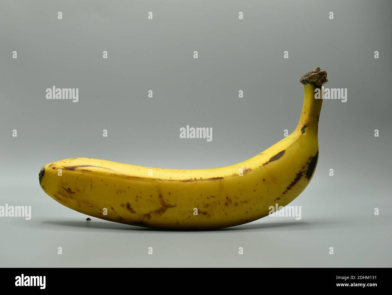 Banana beginning to ripen, side view in photography studio Stock Photo ...