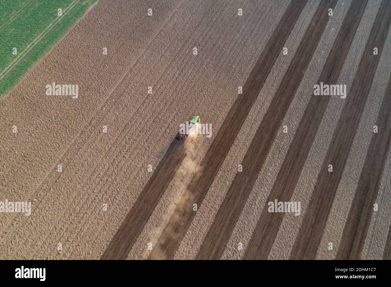 Aerial flight of field with tractor Stock Photo - Alamy