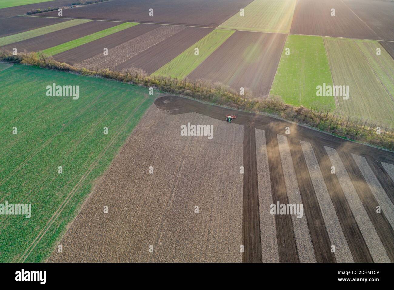 Aerial flight of field with tractor Stock Photo - Alamy