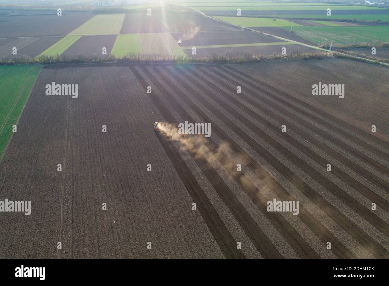 Aerial flight of field with tractor Stock Photo - Alamy