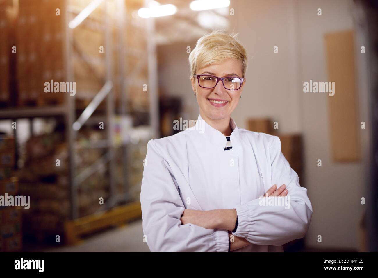Close up of a young happy professional proud female worker in white ...