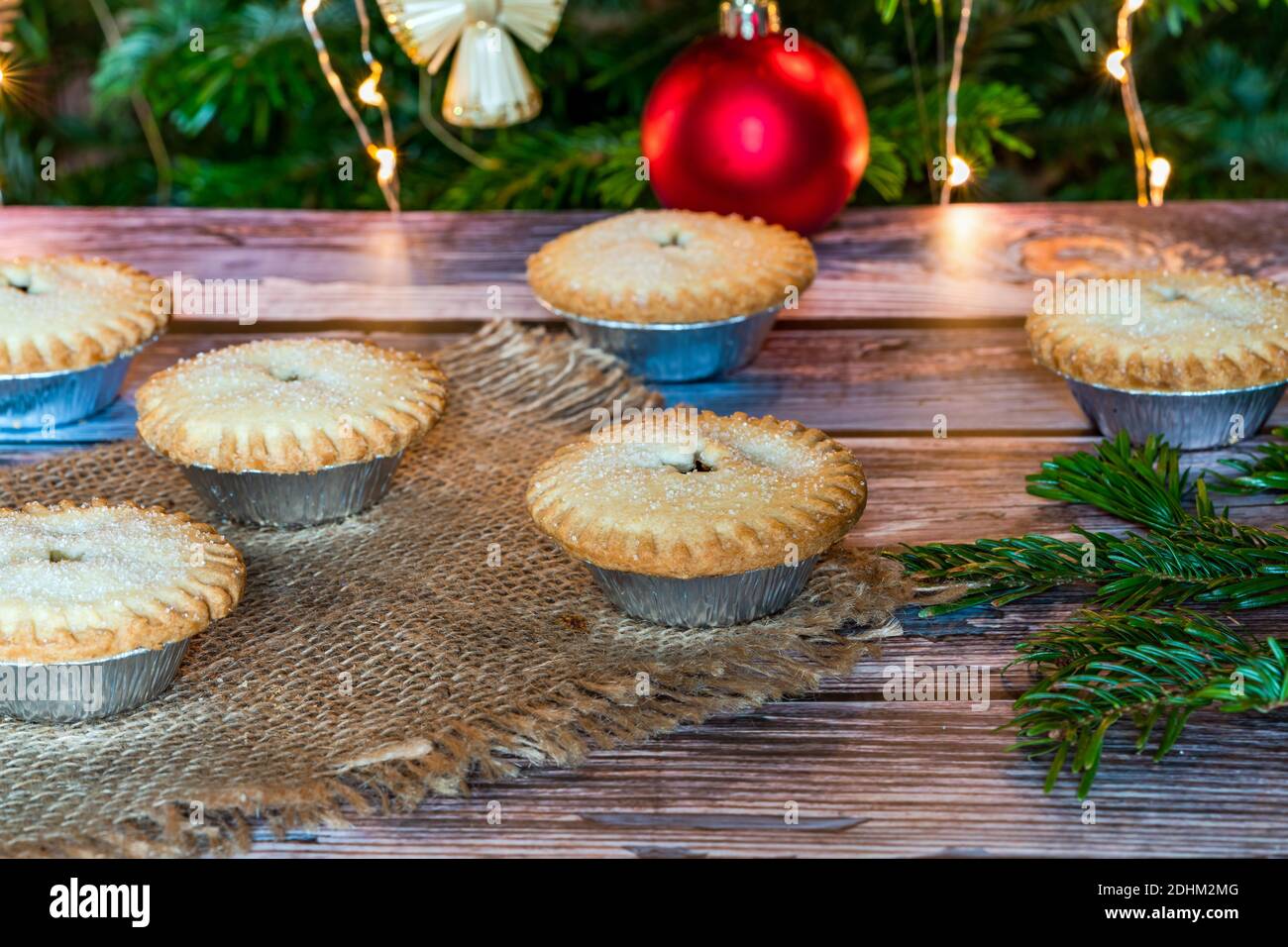 Traditional Christmas mince pies with decorated Christmas tree in the ...