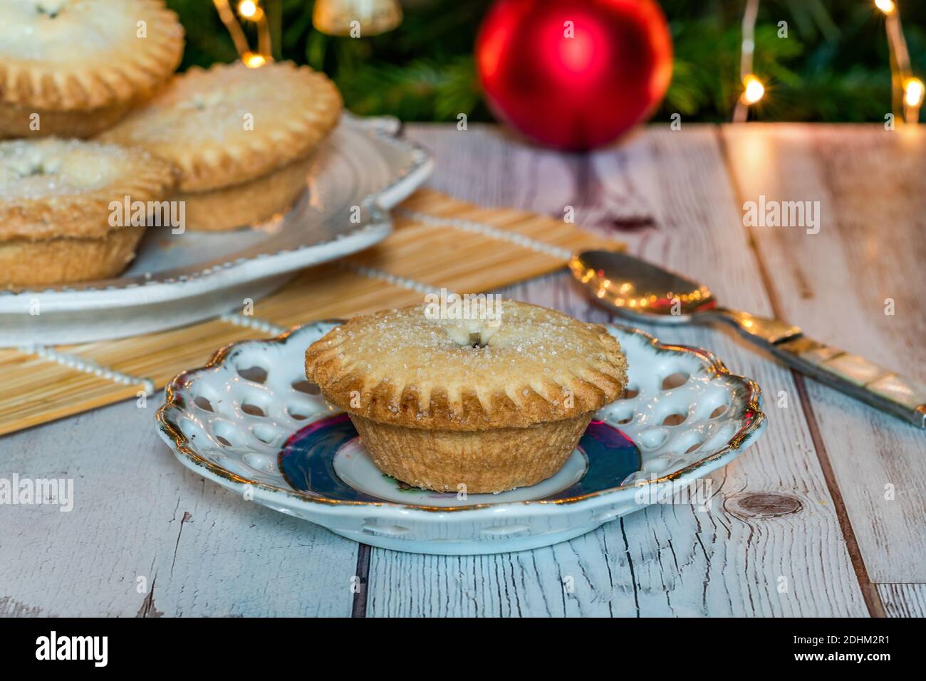 Traditional Christmas mince pies with decorated Christmas tree in the ...