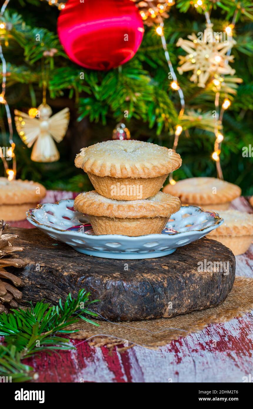 Traditional Christmas mince pies with decorated Christmas tree in the ...