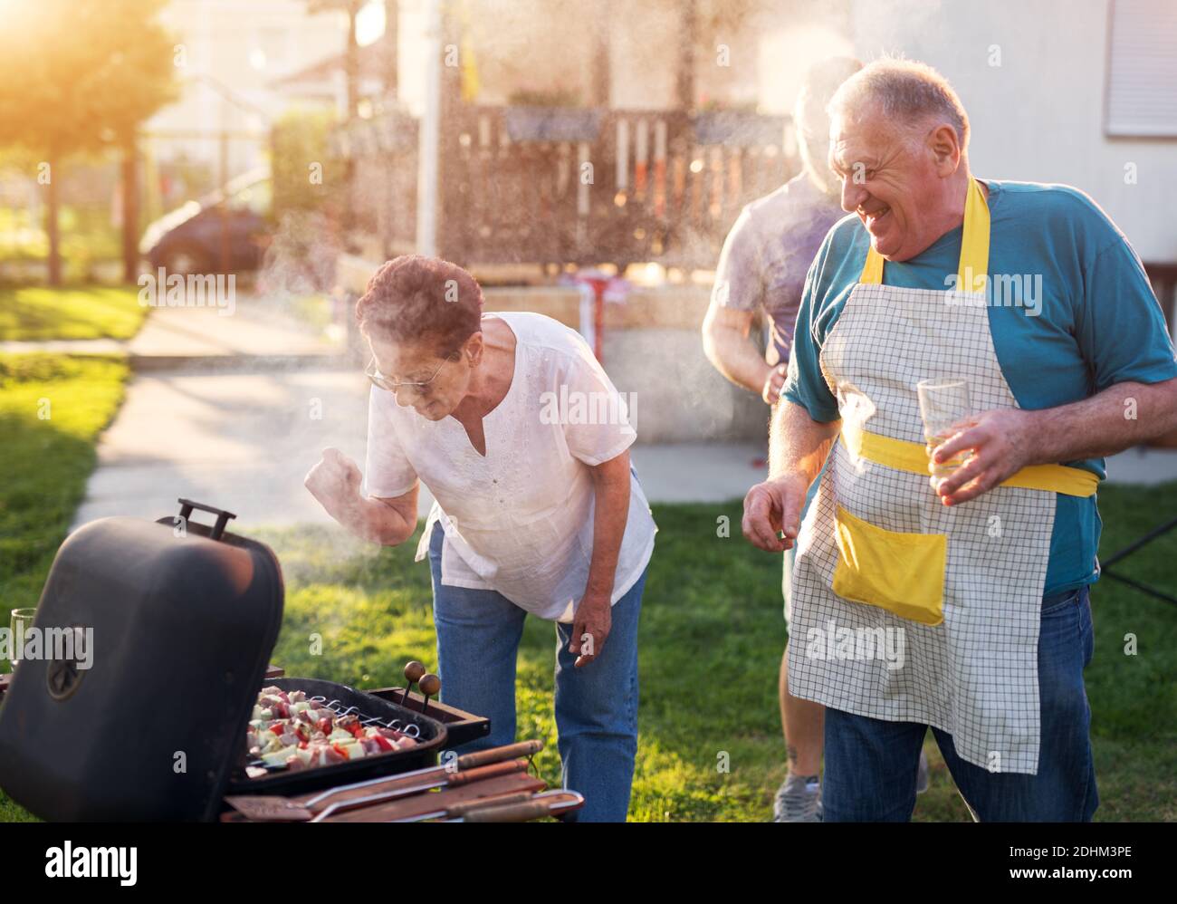 Elderly woman is carefully inspecting should she take meat off the ...