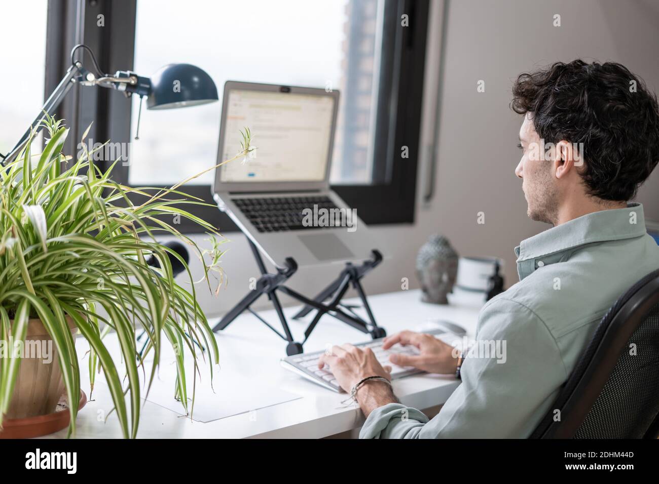 young entrepreneur works from home in his office with the computer in ...