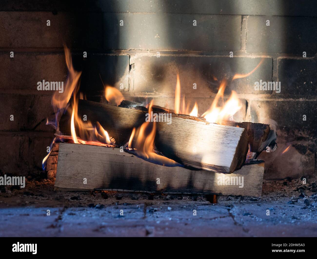 The wood is burning in the fireplace Stock Photo - Alamy