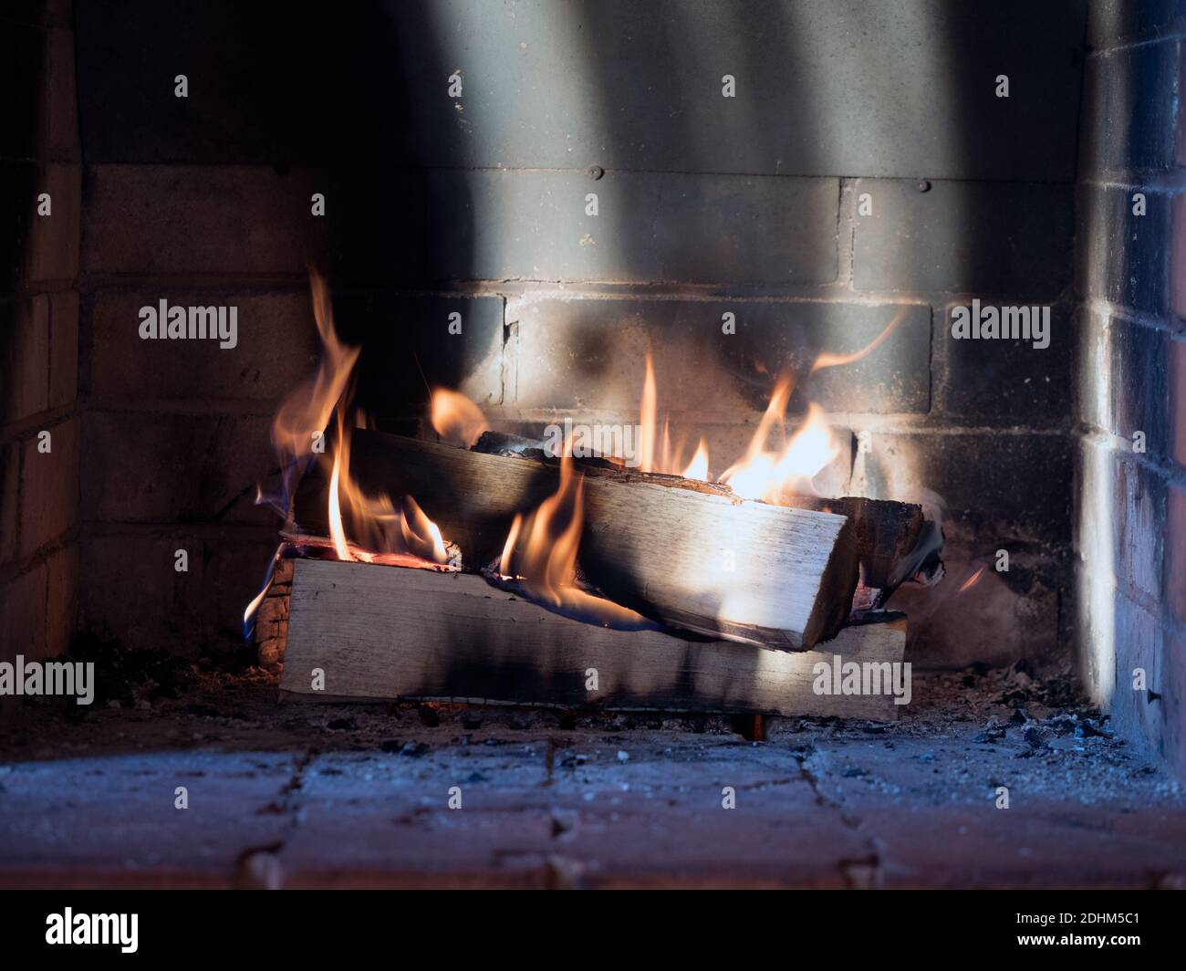 The wood is burning in the fireplace Stock Photo - Alamy