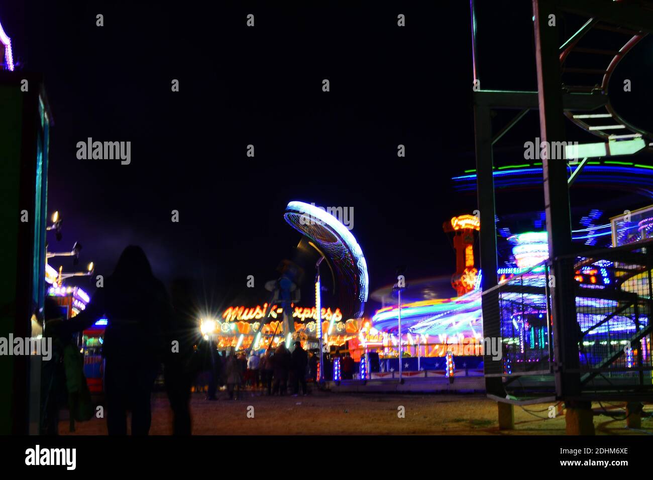 Park with rides at night Stock Photo - Alamy