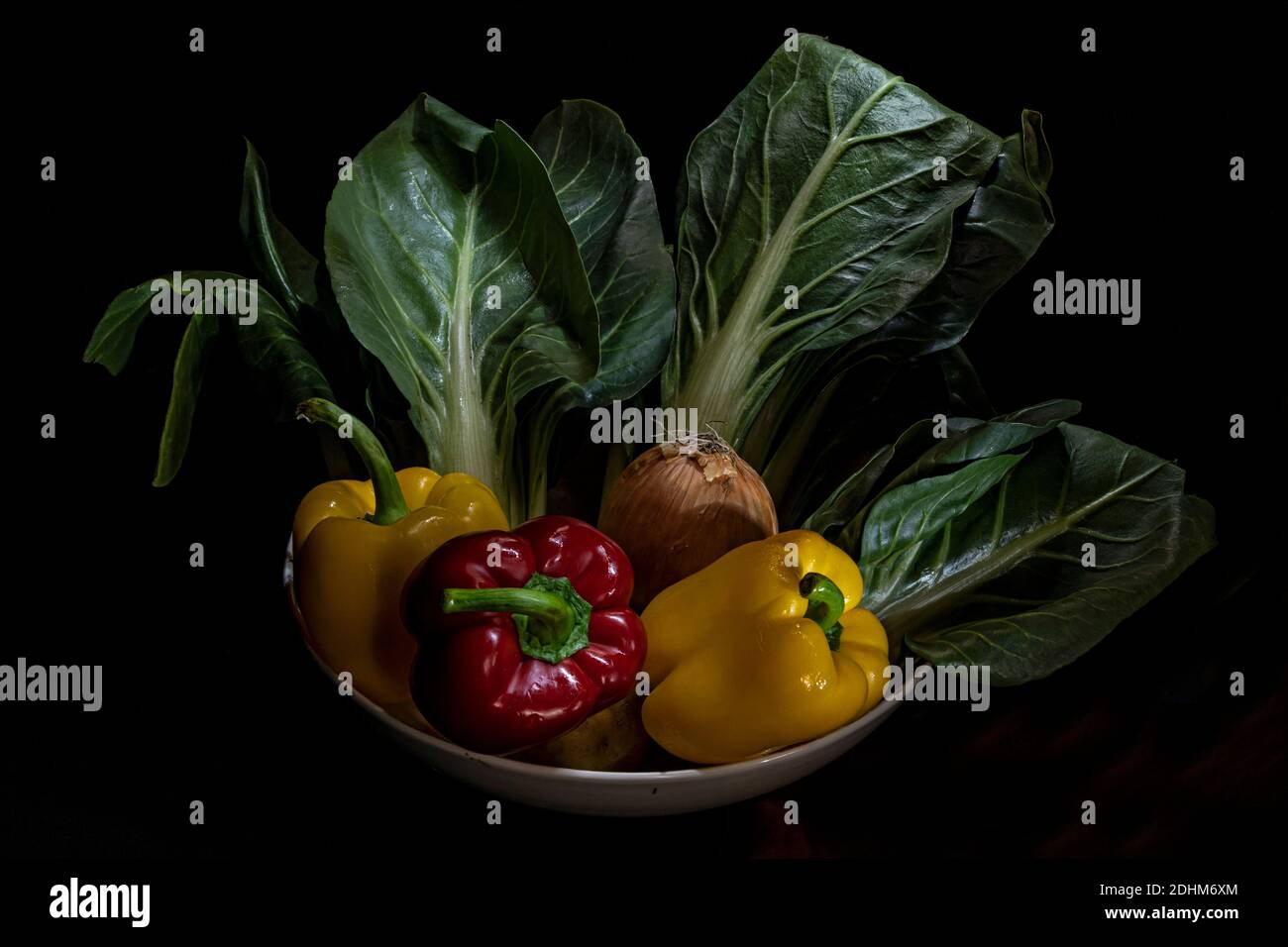 Vegetable composition consisting of two yellow peppers, one red pepper ...