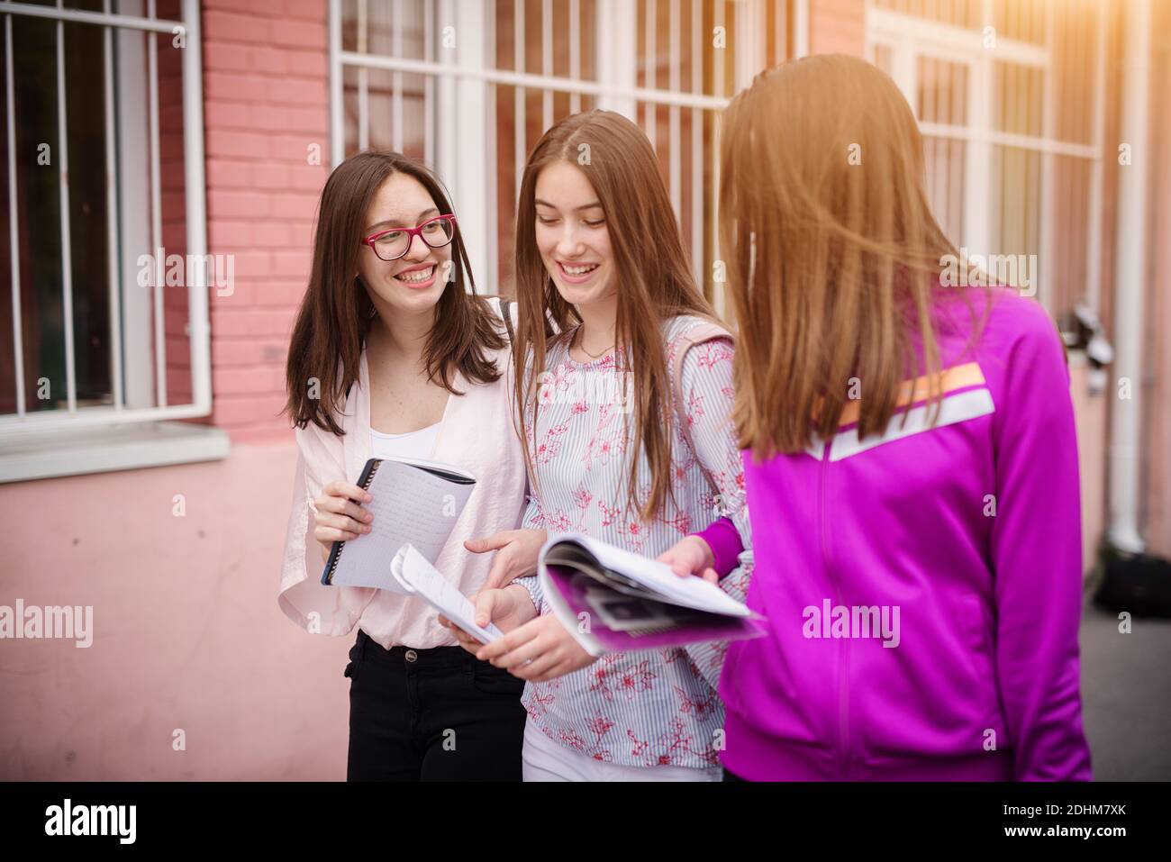 Three beautiful high school girls going together on a break while ...