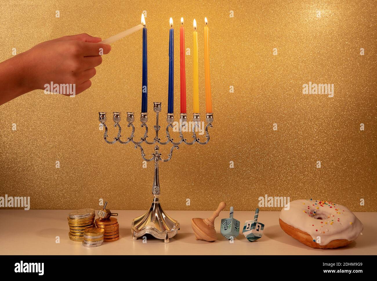 Day 5 of jewish religious holiday Hanukkah with child's hand lighting ...