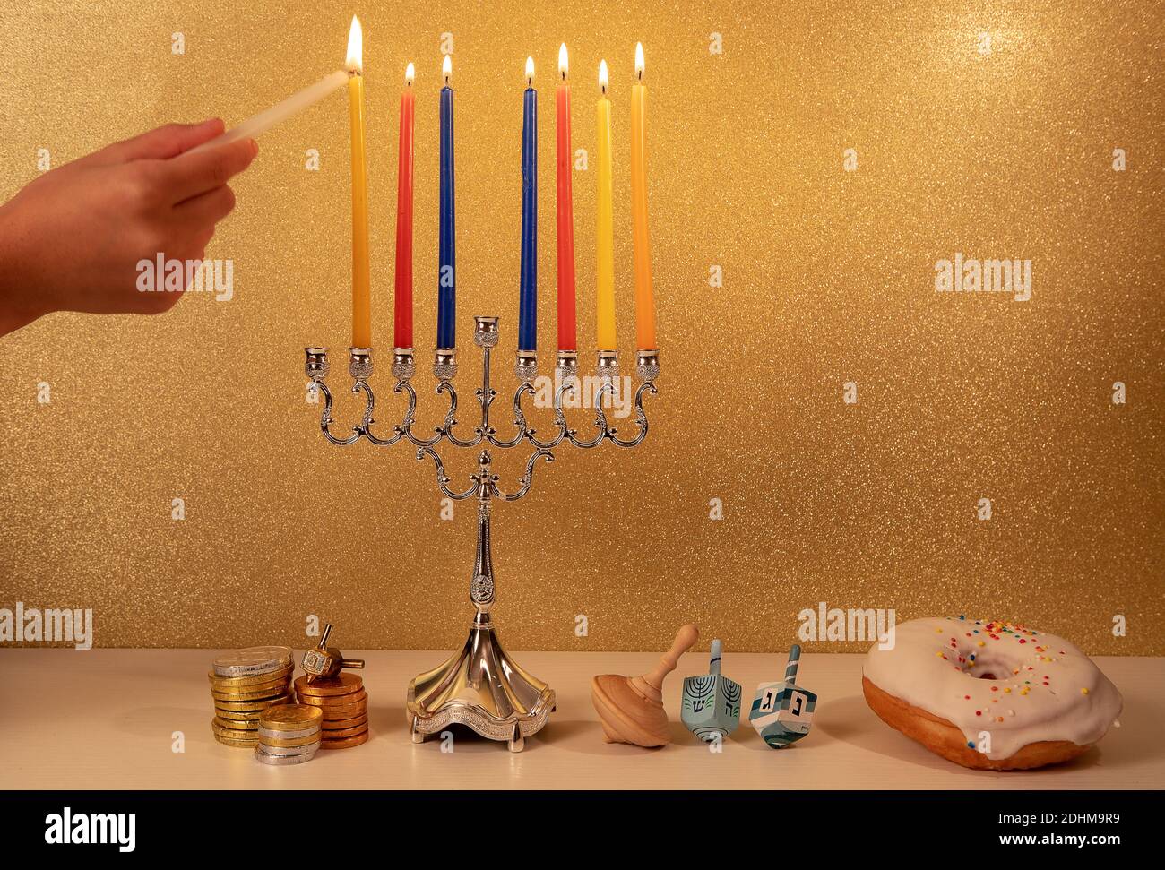 Day 7 of jewish religious holiday Hanukkah with child's hand lighting ...