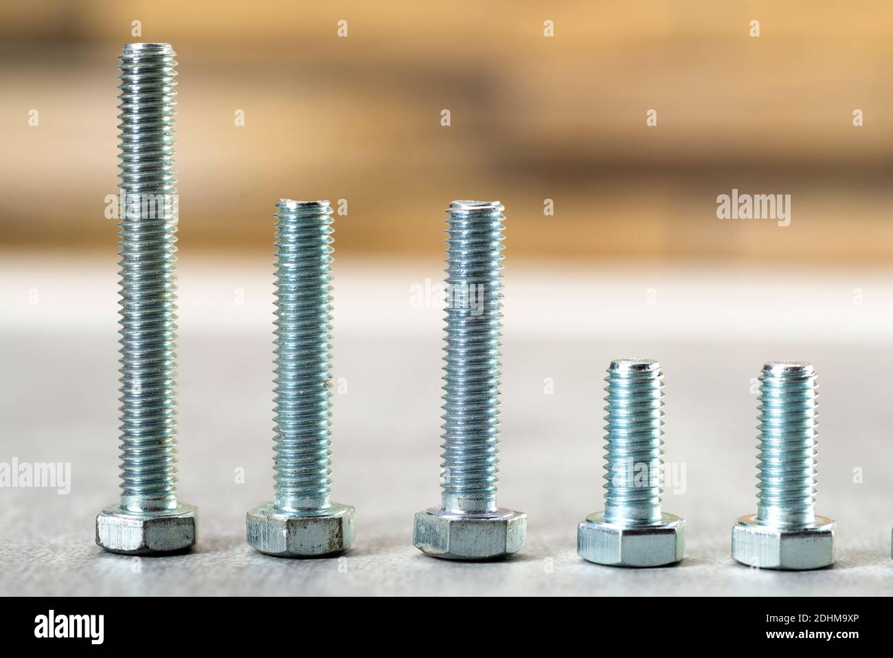 Metal bolts of different lengths on the table Stock Photo - Alamy