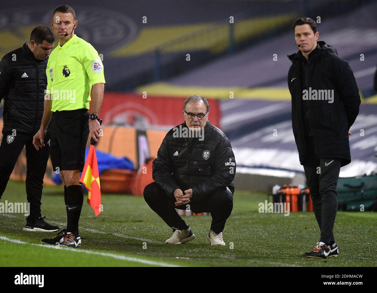 Leeds United manager Marcelo Bielsa squats during the Premier League ...