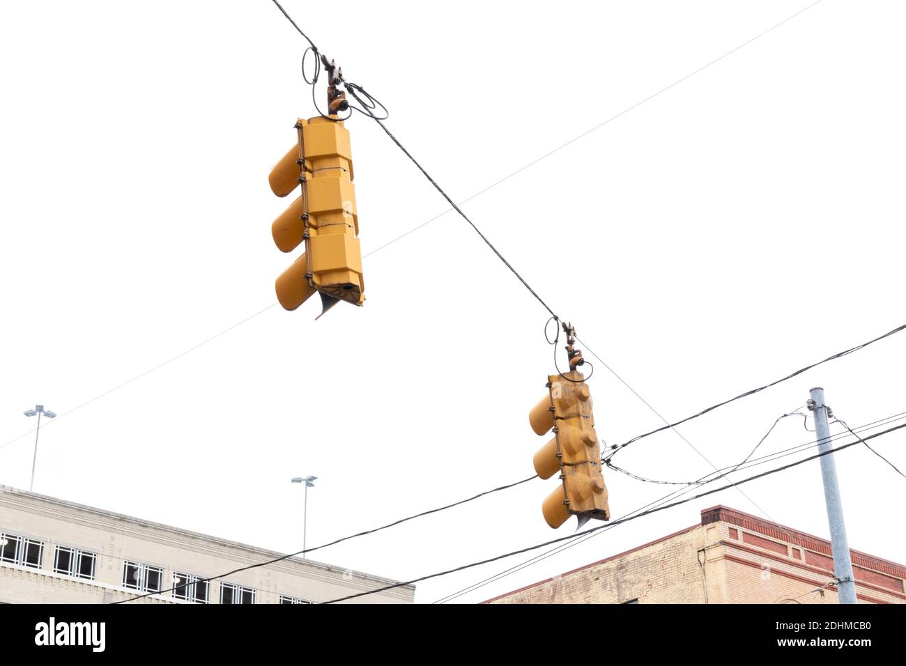 Rear view of traffic signals against an overcast sky, power lines and ...