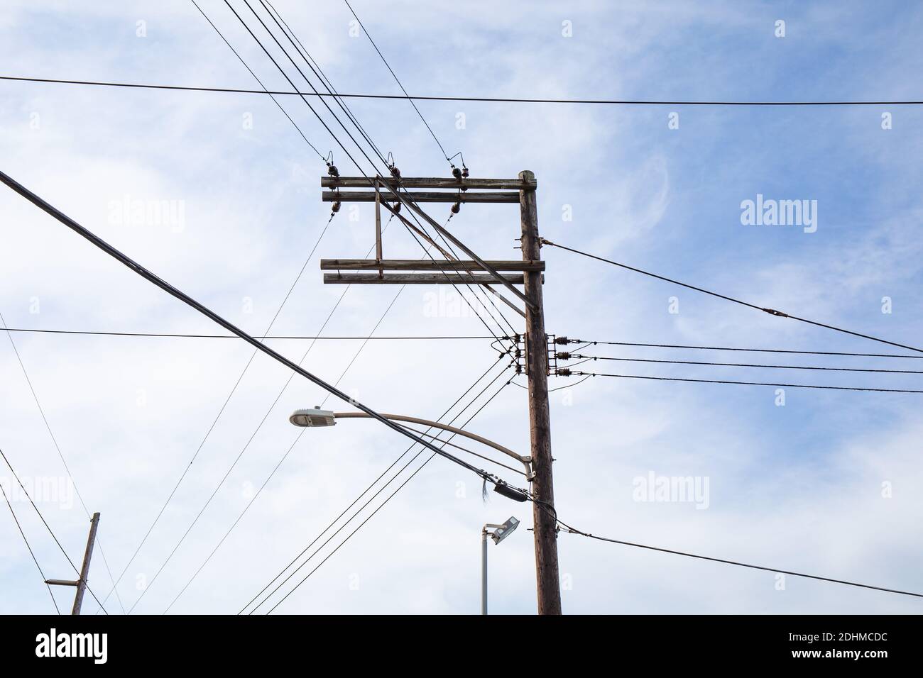 Wood electrical power pole with lines running in multiple directions ...