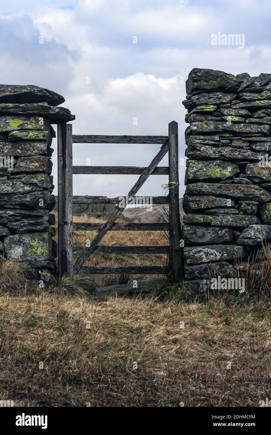 CUMBRIA, UK: Small wooden gate in a traditional dry stone wall in the ...