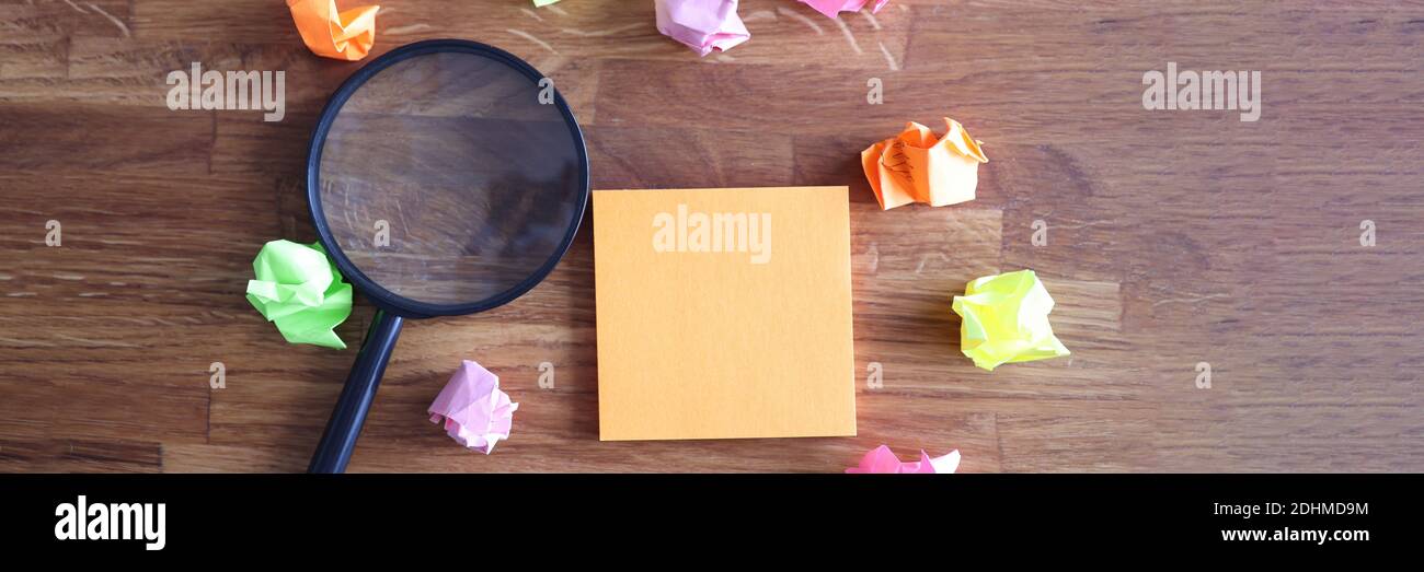 Magnifying glass and colored stickers on table Stock Photo - Alamy