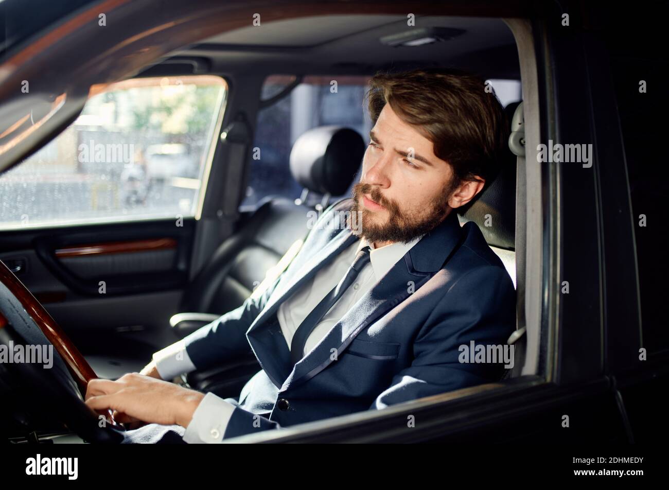 handsome man in suit driving a car trip official lifestyle Stock Photo ...