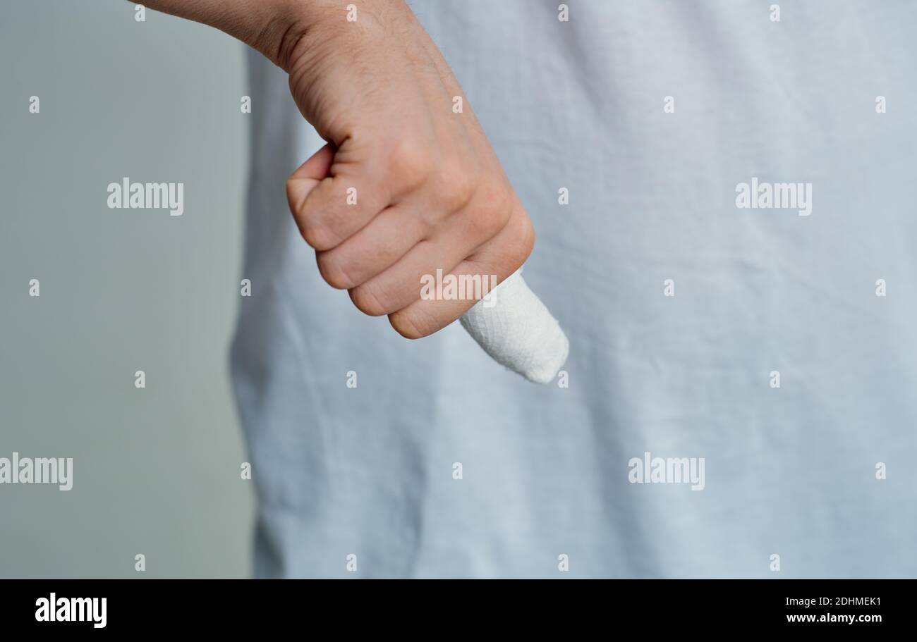 man in white t-shirt broken finger bandaged medicine Stock Photo - Alamy