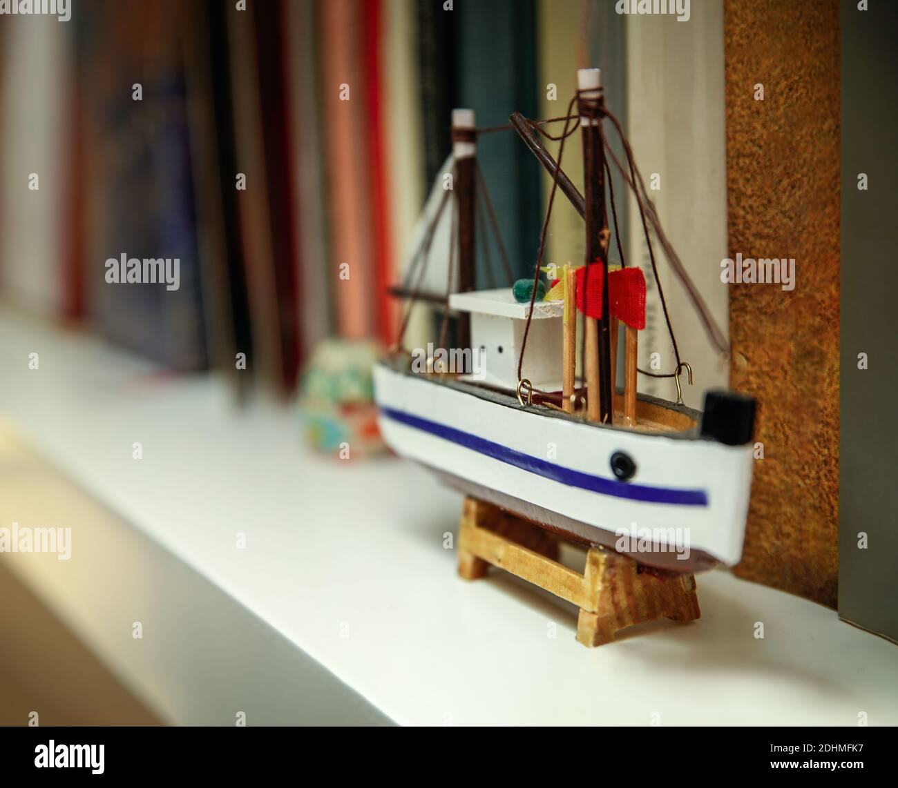 Small wooden ship on a bookshelf, travel - nostalgia concept Stock ...