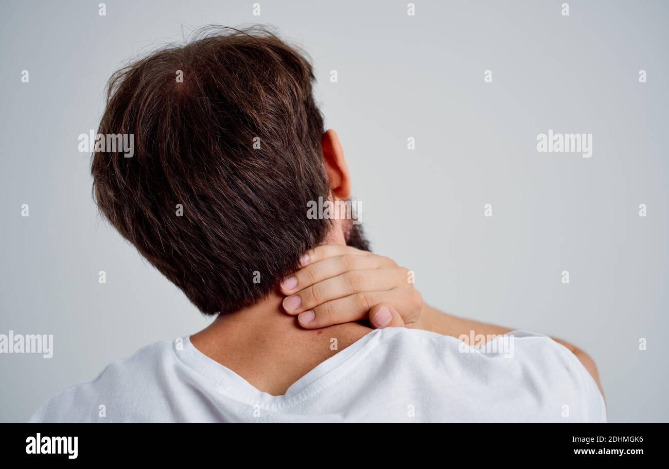 Man touches neck hand hi-res stock photography and images - Alamy