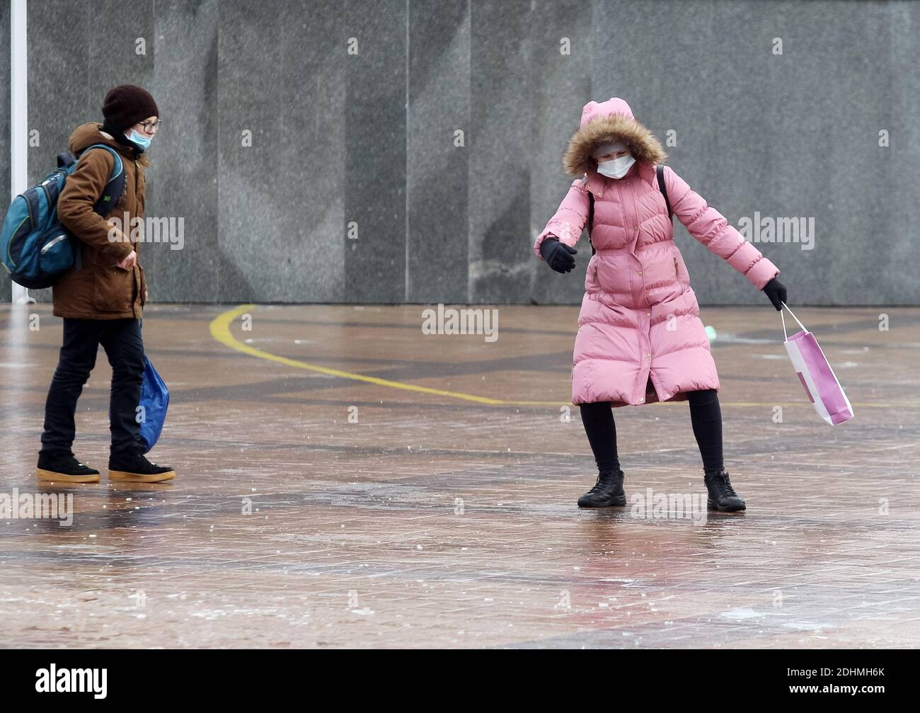 Kiev, Ukraine. 11th Dec, 2020. People wearing face masks walk on a snow ...