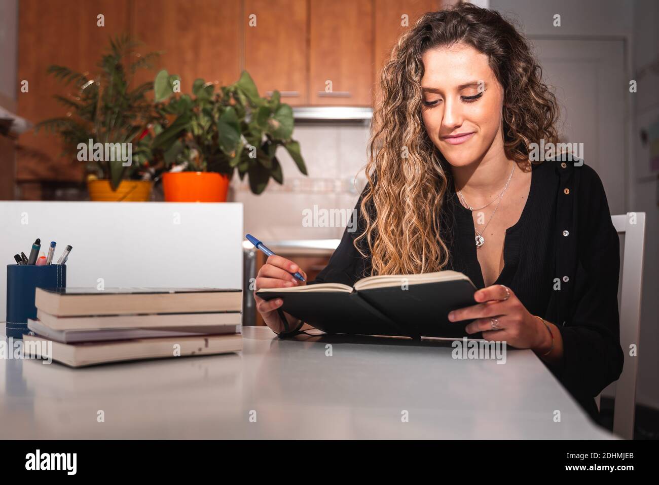 Young woman studying at home Stock Photo - Alamy