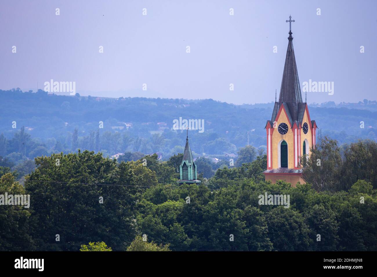 Tower of a christian church piercing through the trees to the sky Stock ...