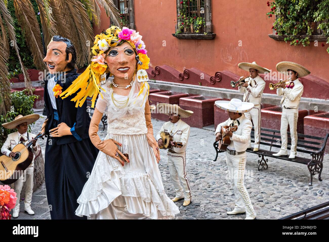 A traditional Mexican mariachi band plays as giant puppets called ...