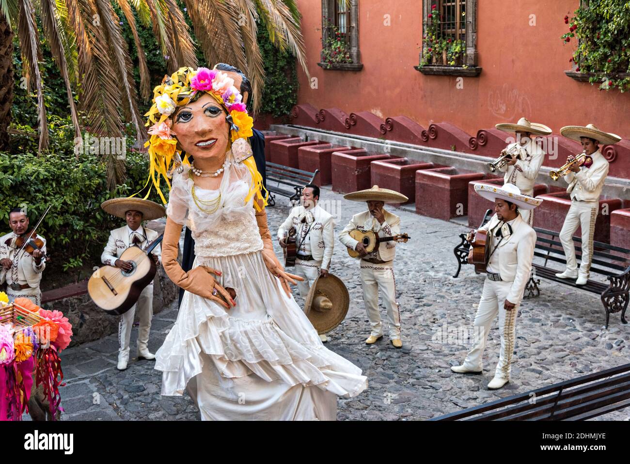 A traditional Mexican mariachi band plays as giant puppets called ...