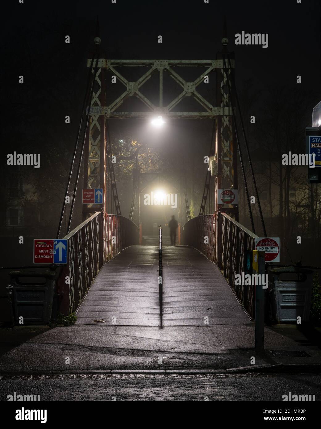 A pedestrian walks across the Gaol Ferry Bridge over the River Avon on ...