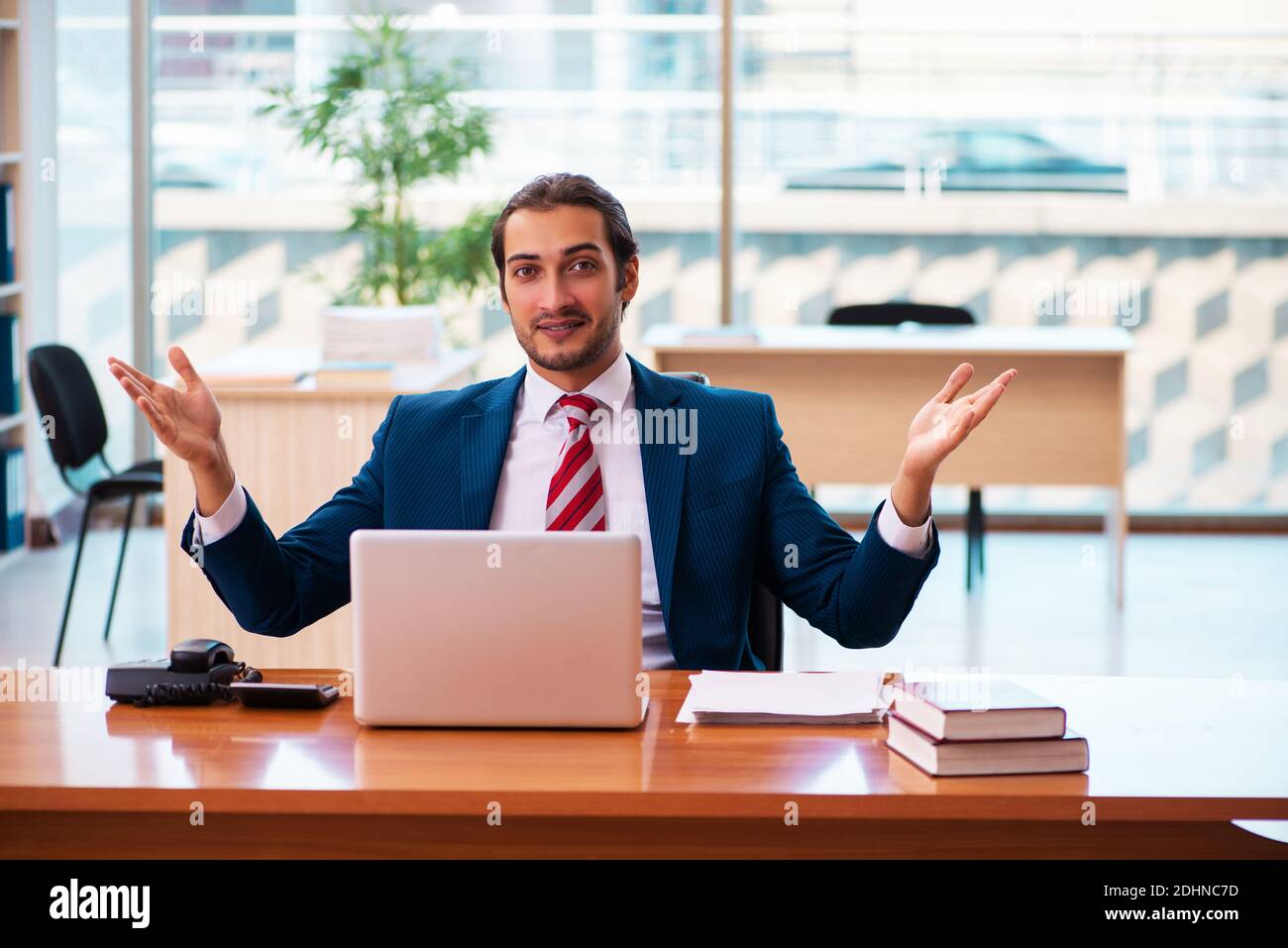 Young attractive male employee working in the office Stock Photo - Alamy