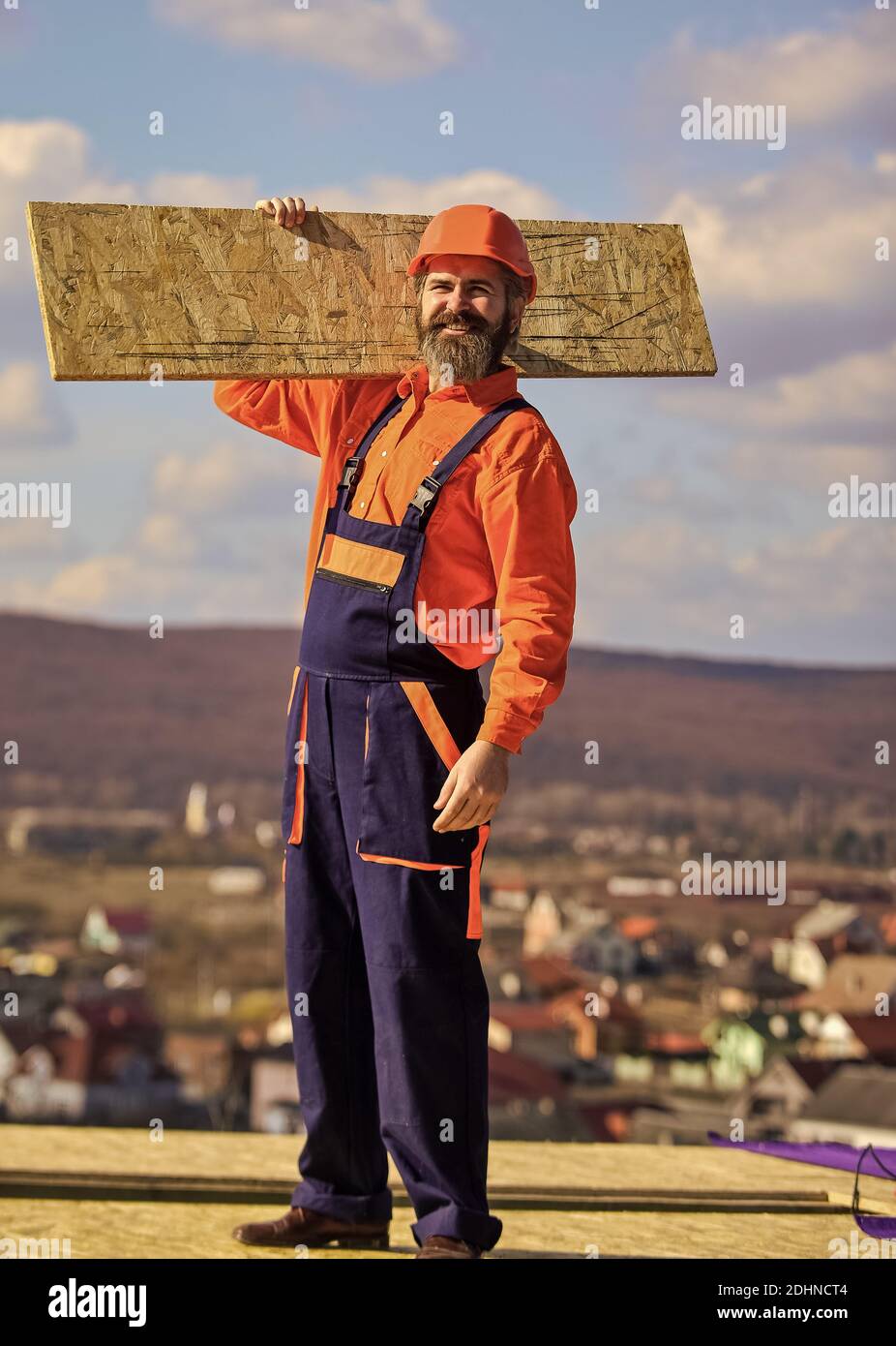 Carpenter in despair. construction work with roofing felt. roof ...