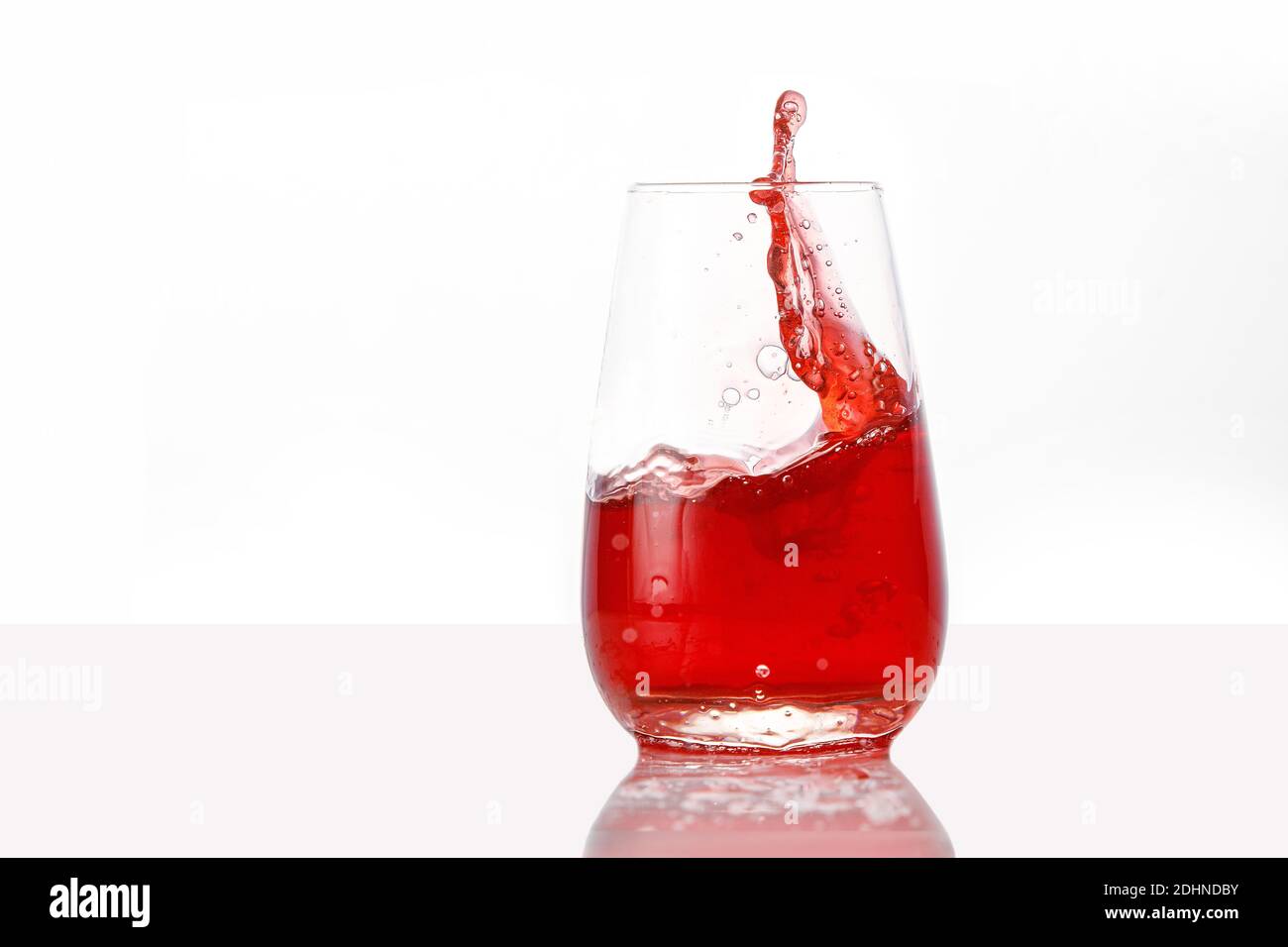Red juice splashes on isolated white background Stock Photo - Alamy