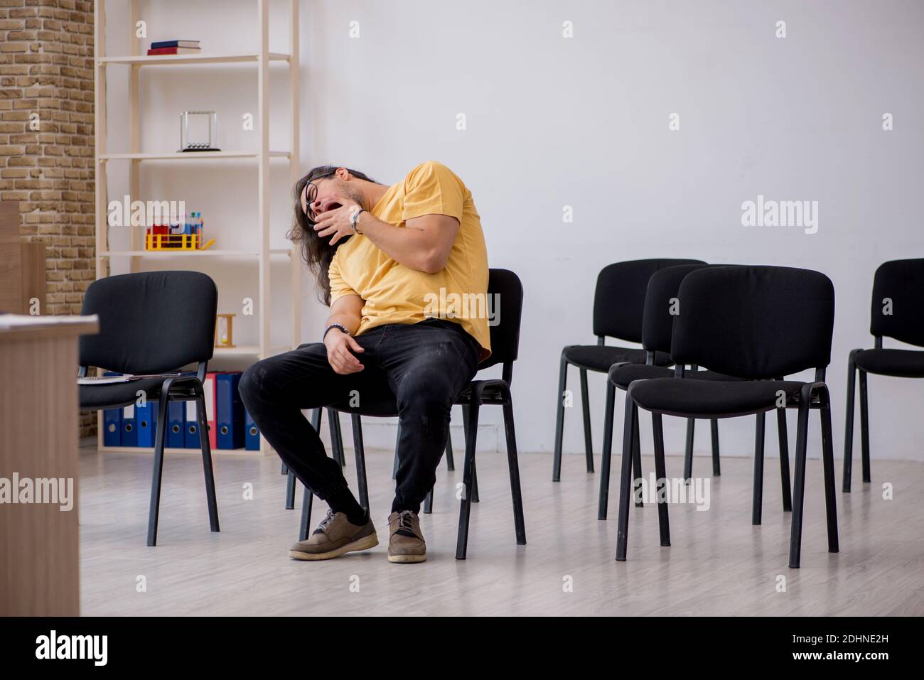 Young student waiting for teacher in the classroom Stock Photo - Alamy