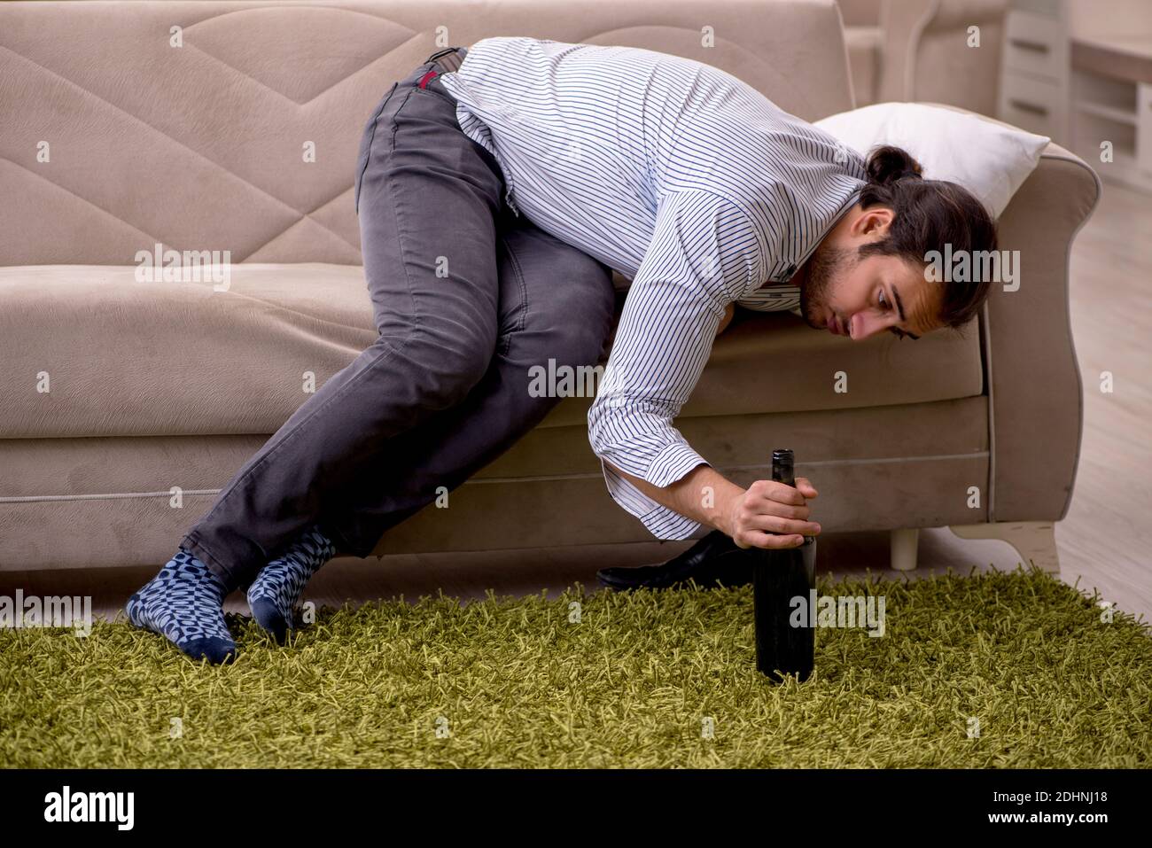 Young drunken man suffering at home Stock Photo - Alamy