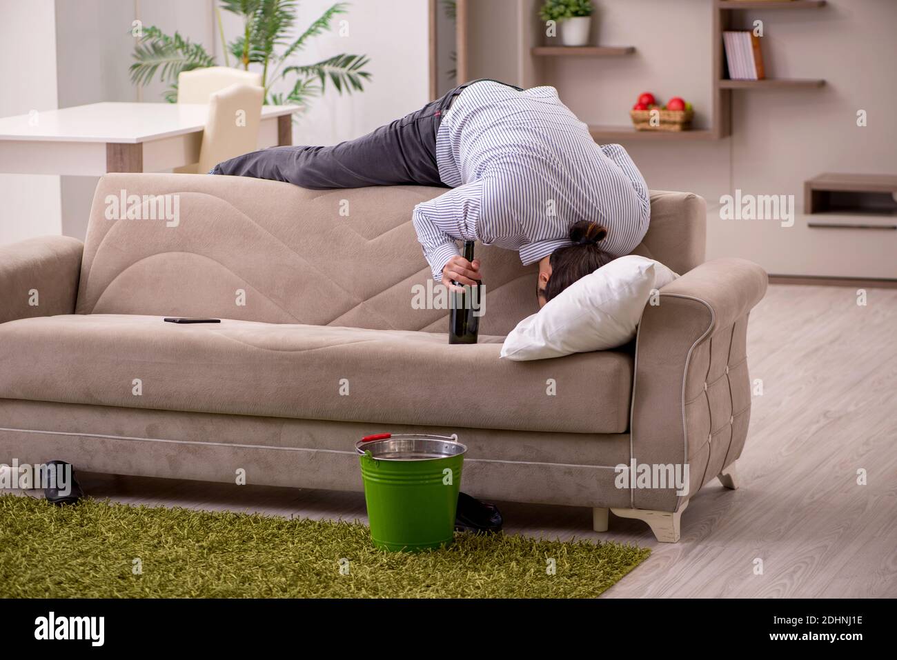Young drunken man suffering at home Stock Photo - Alamy
