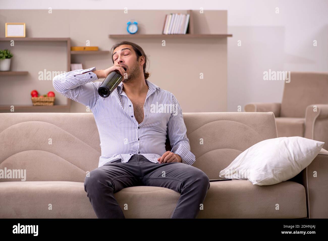 Young drunken man suffering at home Stock Photo - Alamy