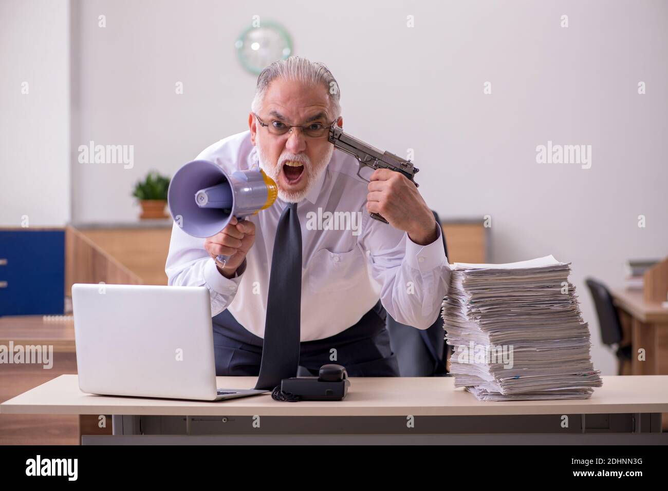 Old employee being desperate with excessive work in the office Stock ...