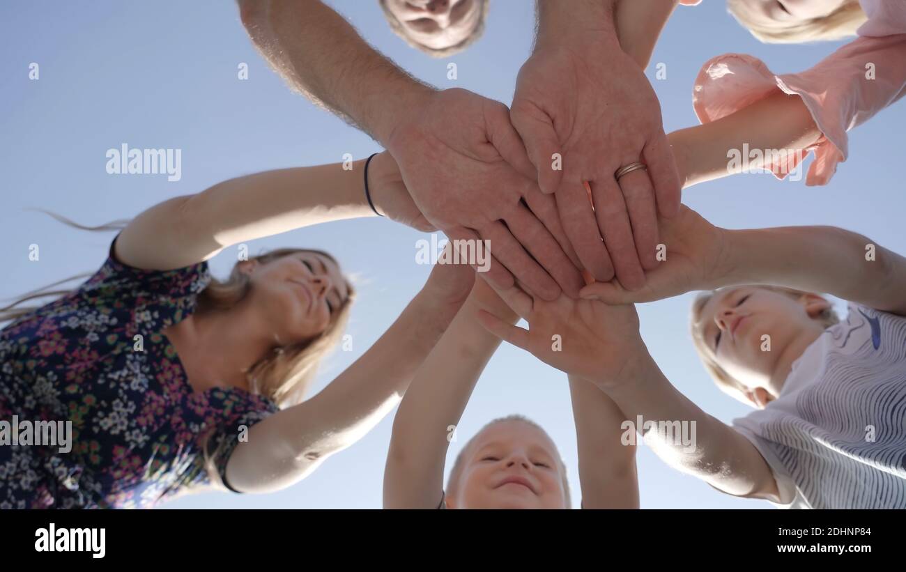 Children and parents join hands together. Joint success concept Stock ...
