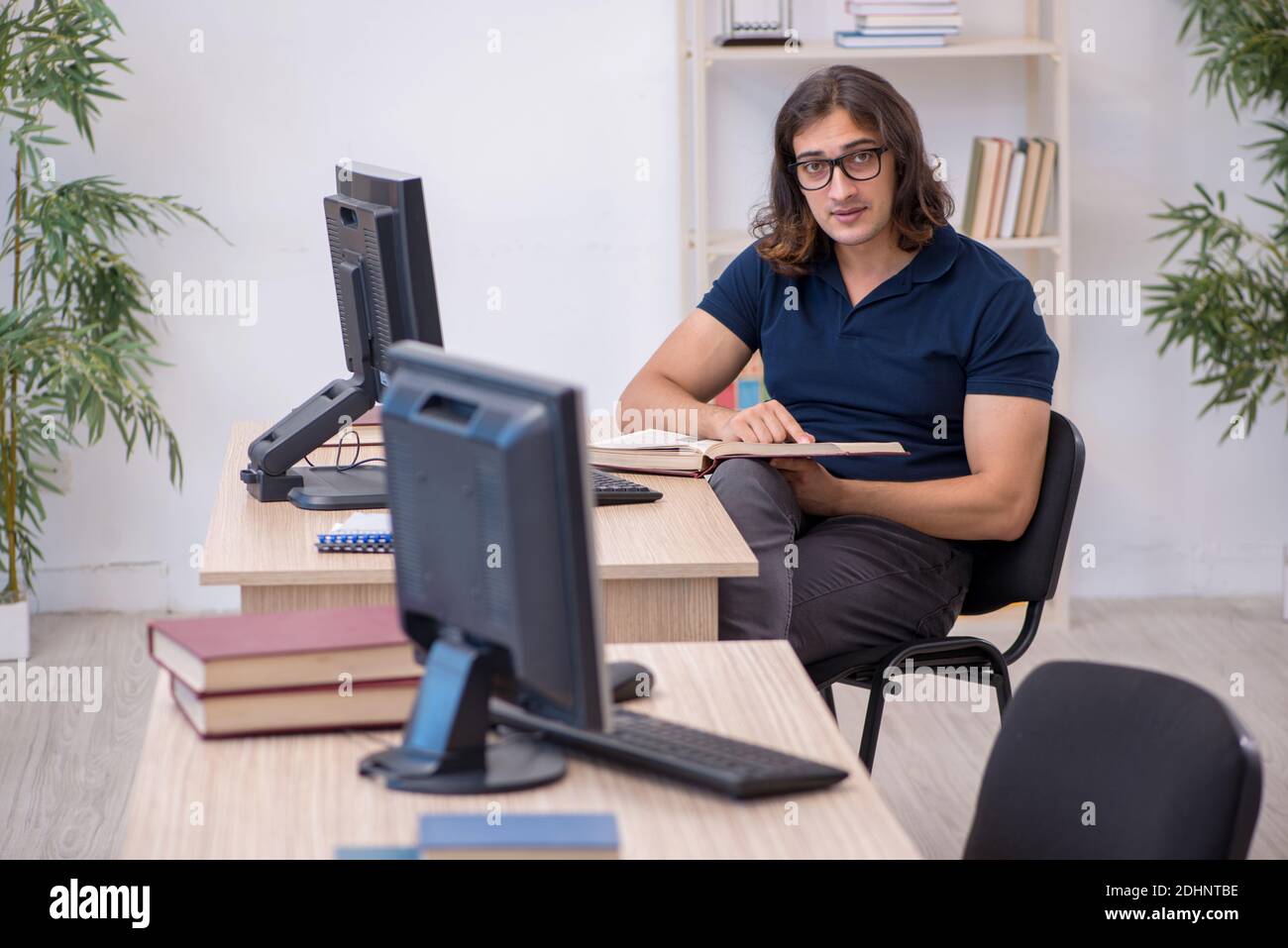 Young student preparing for exams in the classroom Stock Photo - Alamy