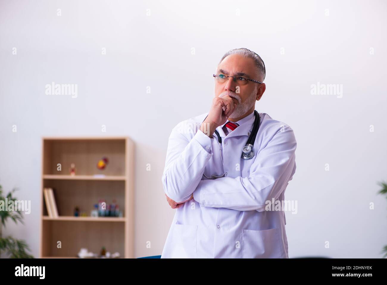 Focused senior old doctor working hi-res stock photography and images ...